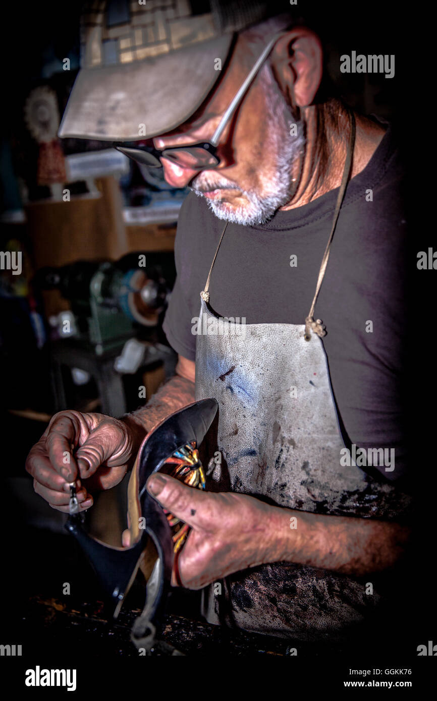 adult male shoemender working at his own workshop Stock Photo - Alamy
