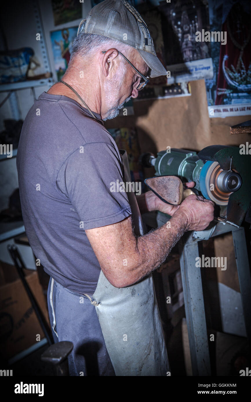 adult male shoemender working at his own workshop Stock Photo - Alamy