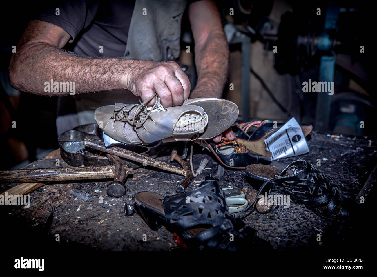 adult male shoemender working at his own workshop Stock Photo - Alamy