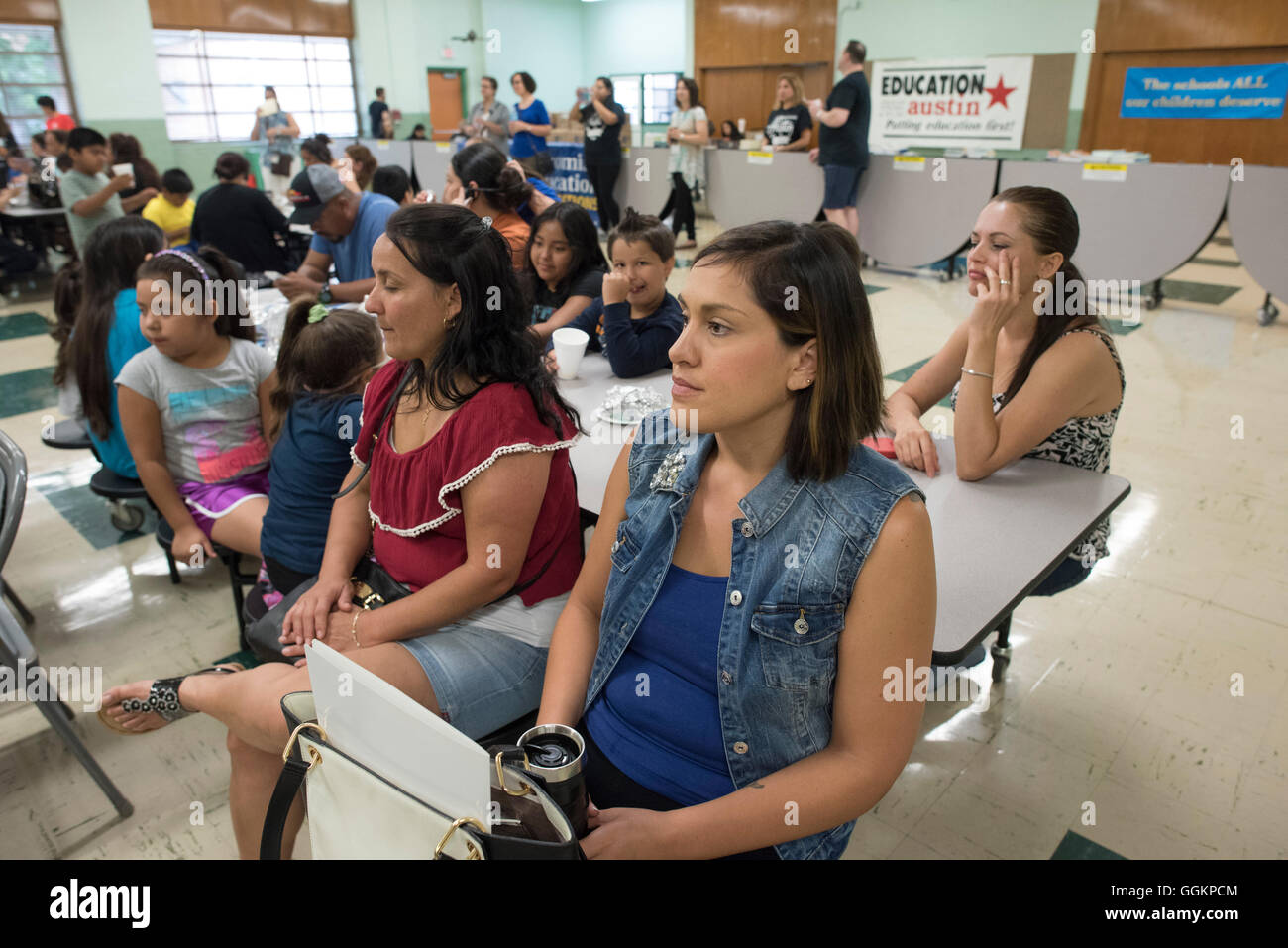 Parents and kids listen to speaker at workshop for parents, teachers ...