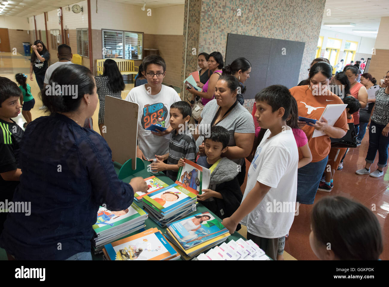 Kids and parents look through free school supplies and books at Colorin ...
