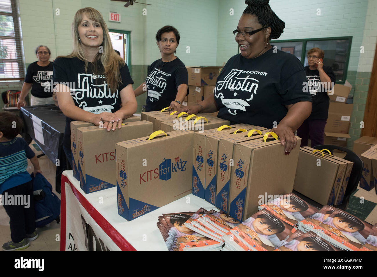 Volunteers ready to hand out school supplies to young students at ...