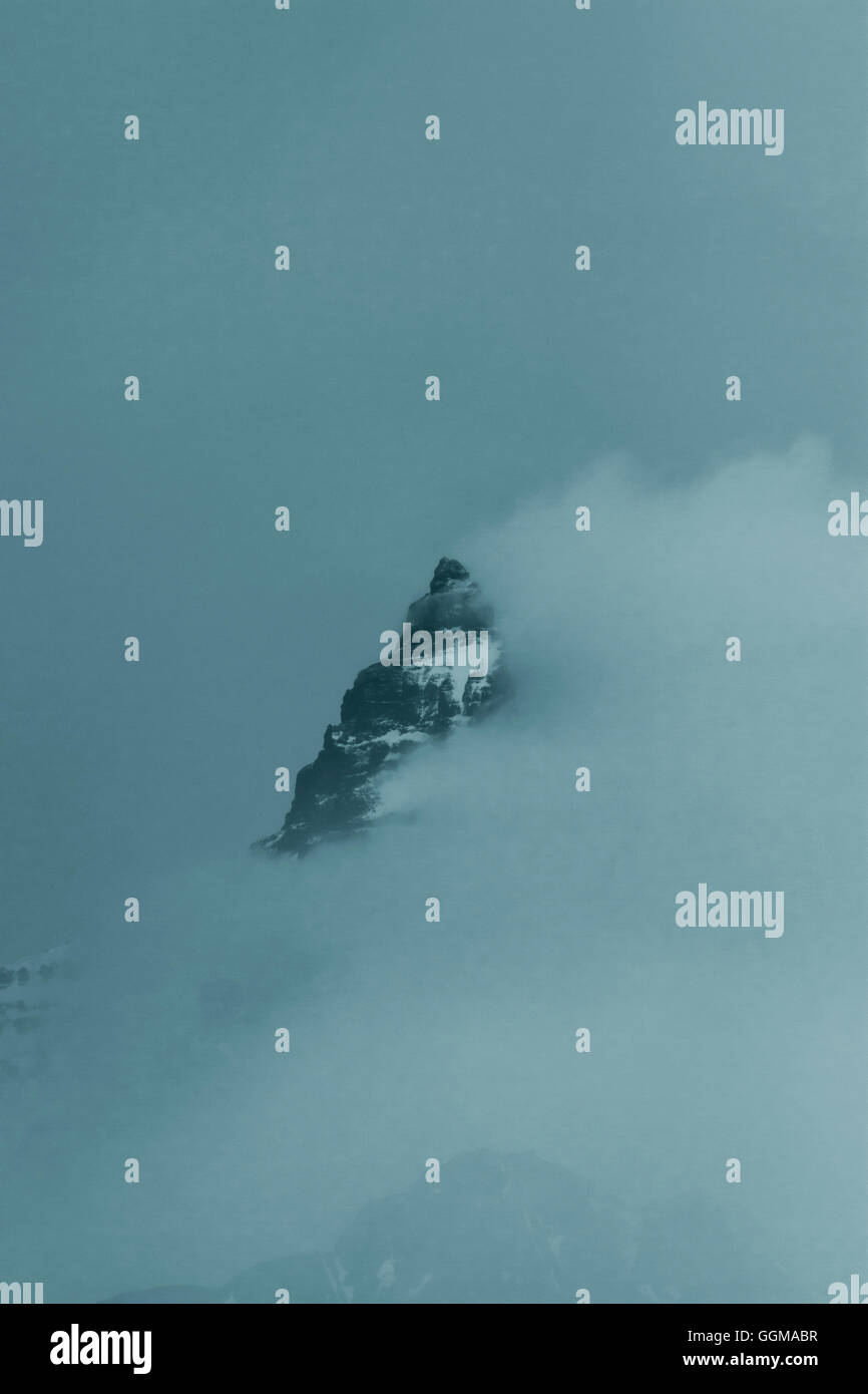 Pilot Peak is visible as winds blow aside mist and clouds. Viewpoint is ...