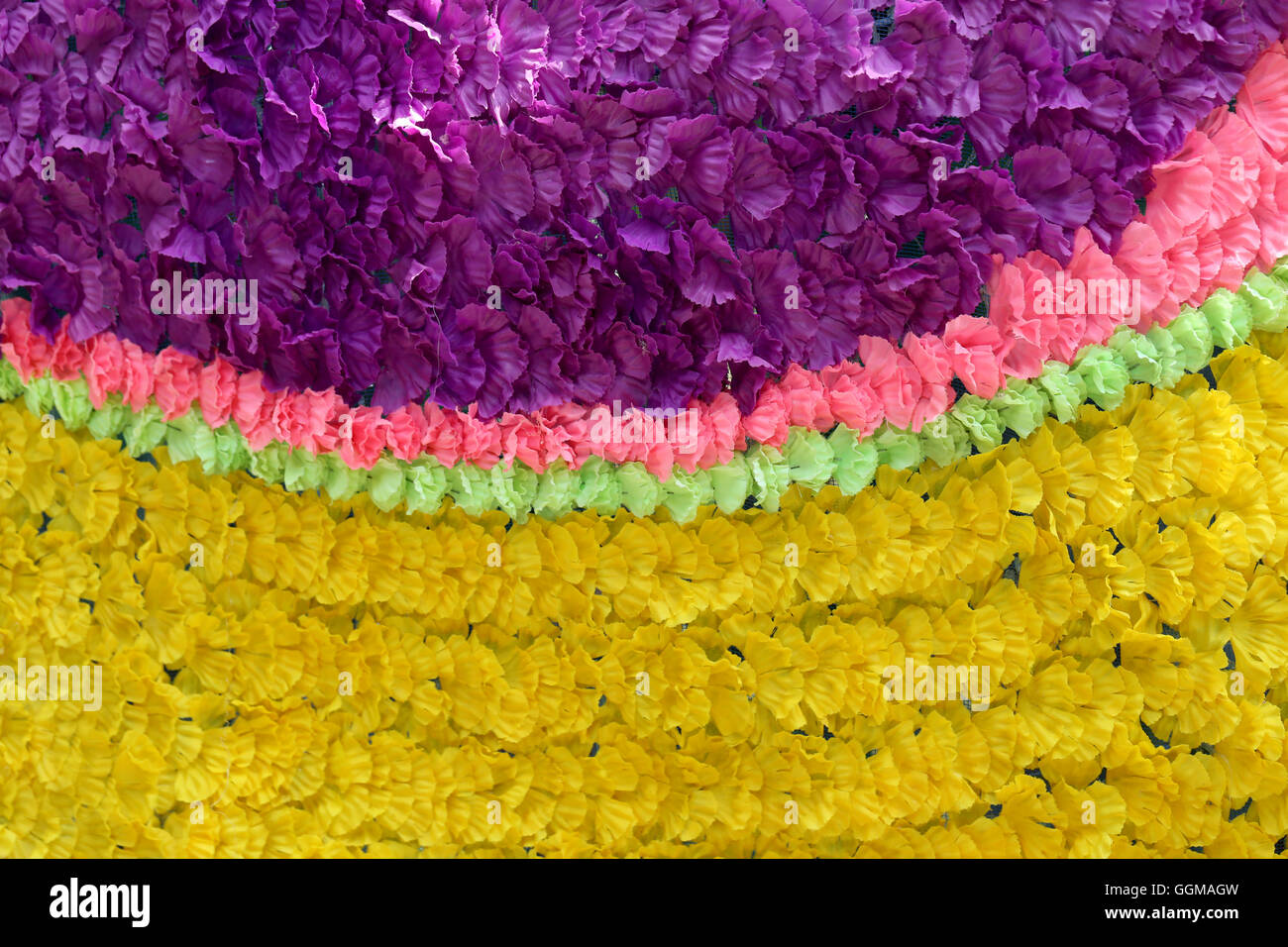 Background of colorful fake flowers that decorated the backdrop for the ...