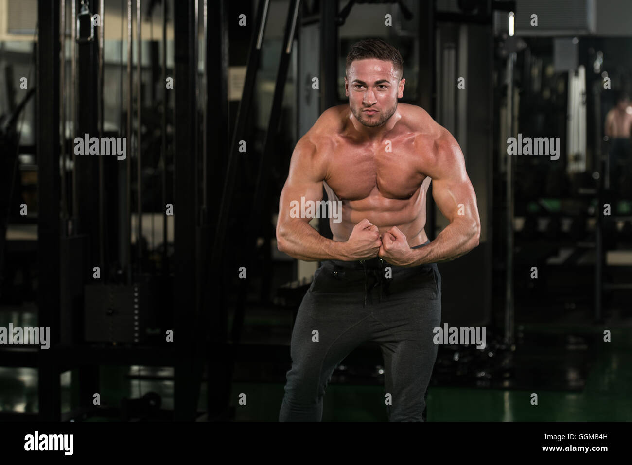 Portrait Of A Young Physically Fit Man Making Most Muscular Pose ...