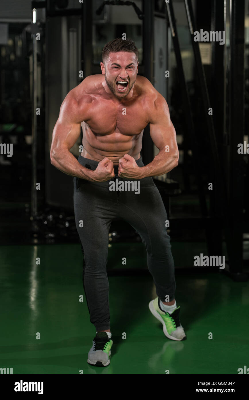 Portrait Of A Young Physically Fit Man Making Most Muscular Pose ...