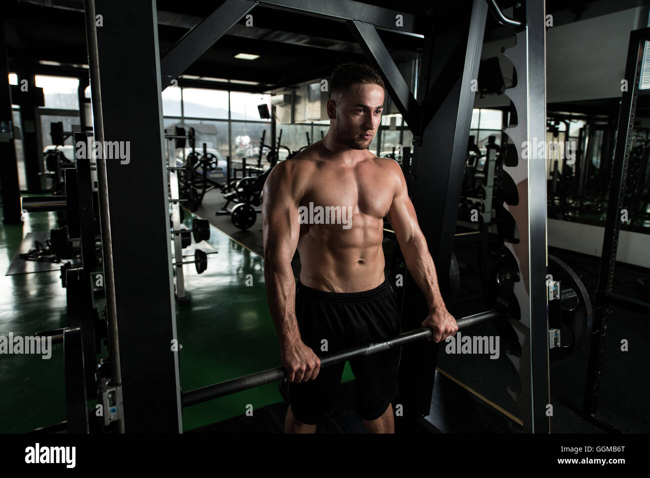 Portrait Of A Young Physically Fit Man Making Most Muscular Pose ...