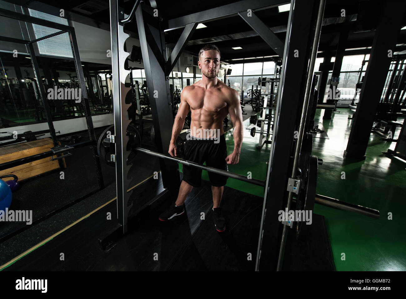 Portrait Of A Young Physically Fit Man Making Most Muscular Pose ...