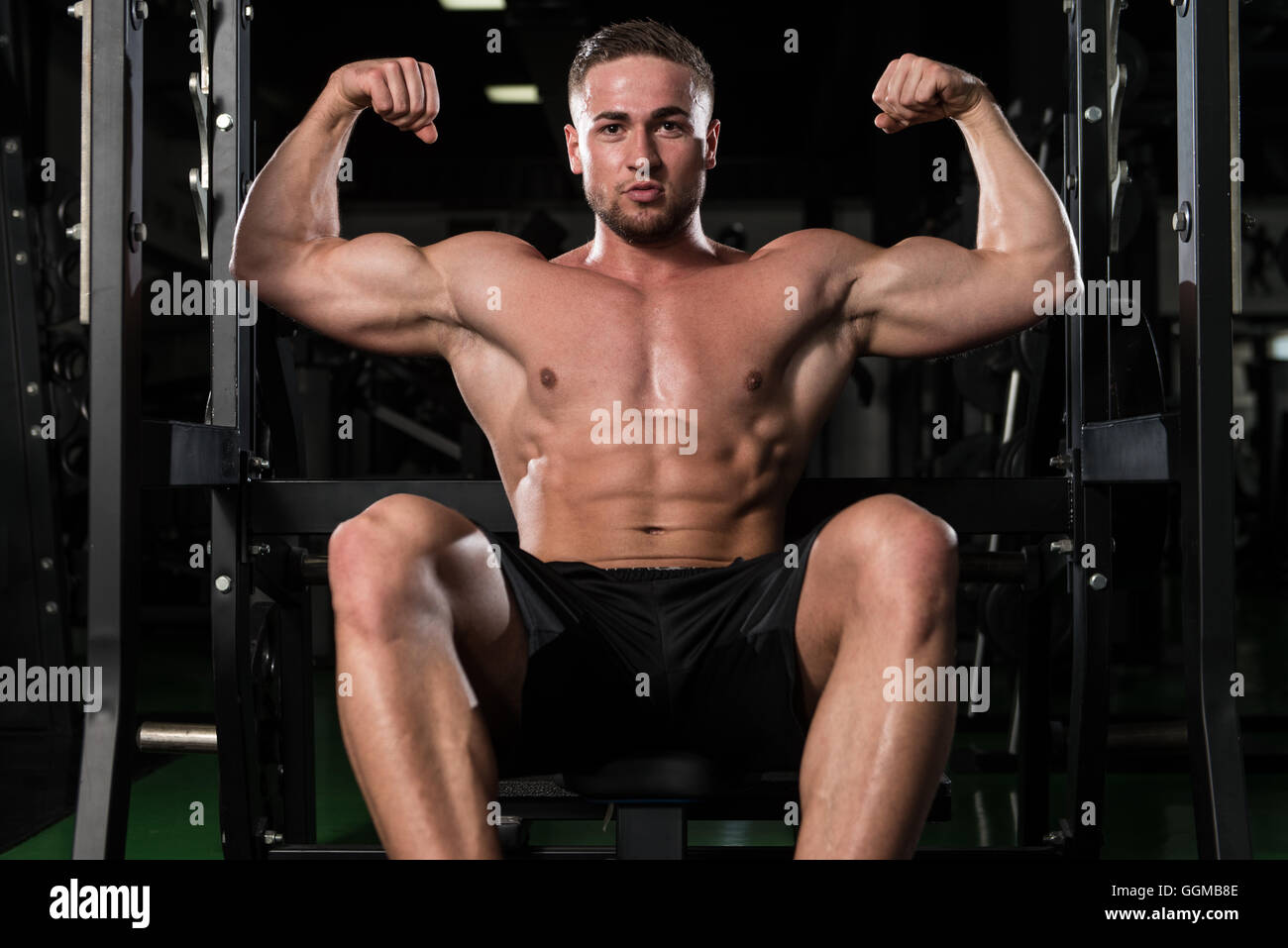 Portrait Of A Young Physically Fit Man Performing Biceps Pose ...