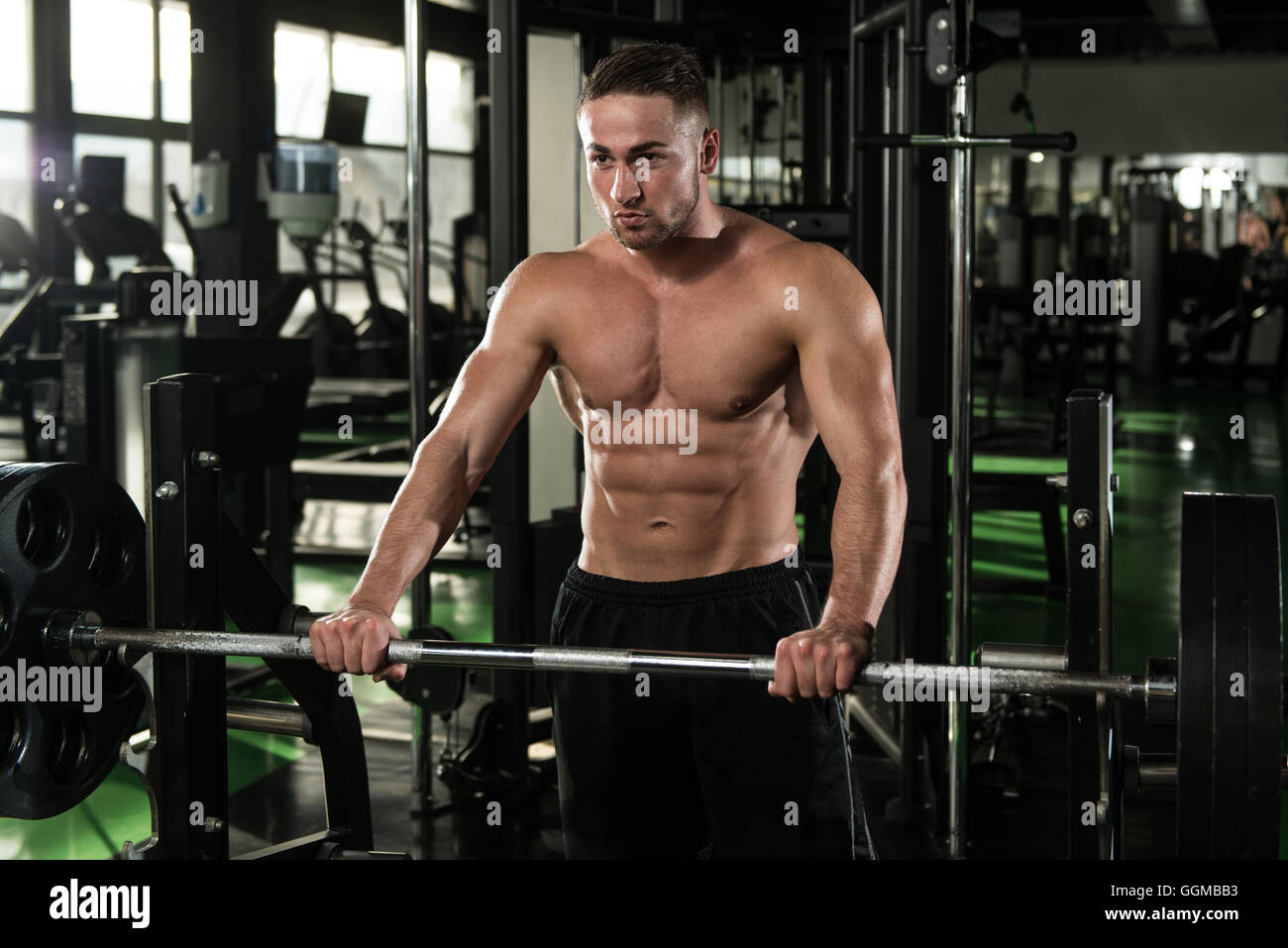 Portrait Of A Young Physically Fit Man Making Most Muscular Pose ...