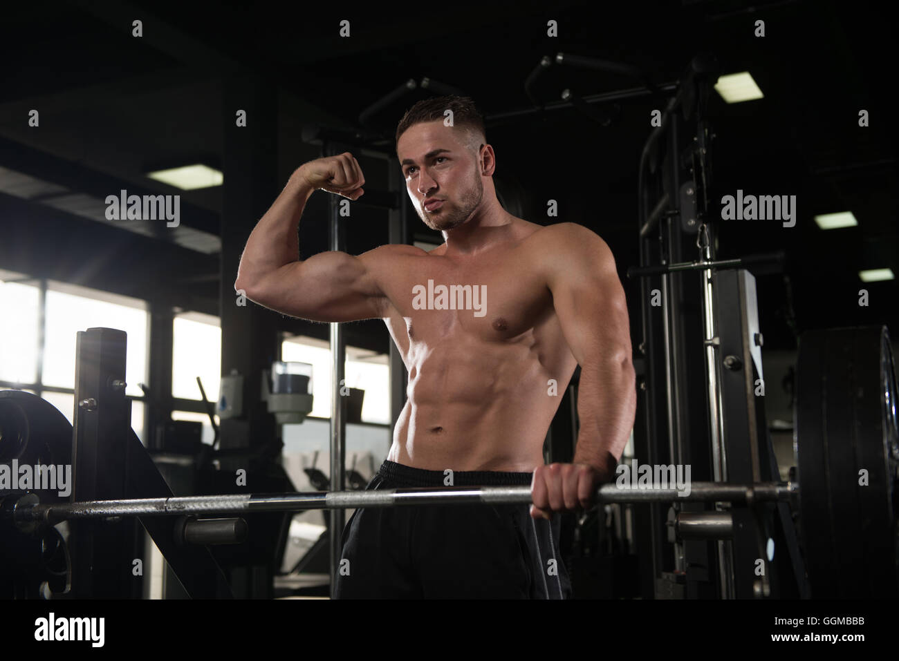Portrait Of A Young Physically Fit Man Making Most Muscular Pose ...