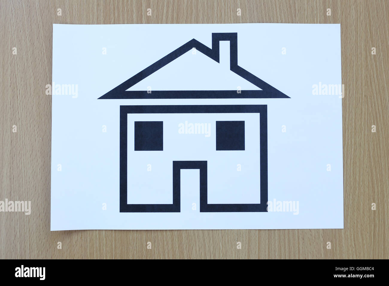 Paper shaped house on a background of brown wood,Ideas for the design ...