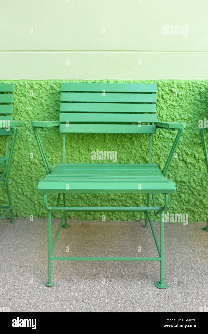 green wooden park bench in the public park are nobody and have space to ...