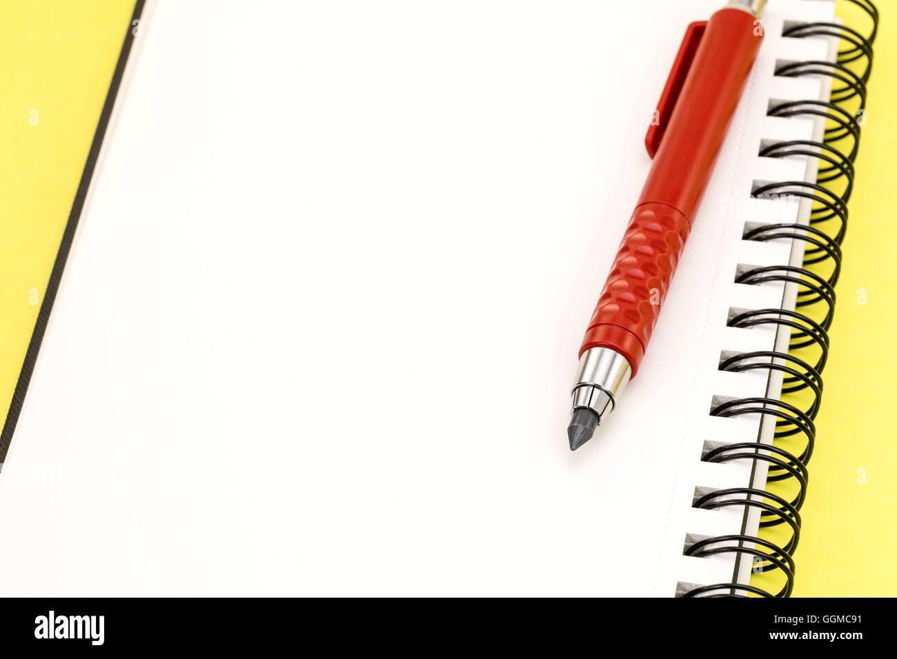 yellow writing desk with mechanic pencil and empty notebook on it Stock ...