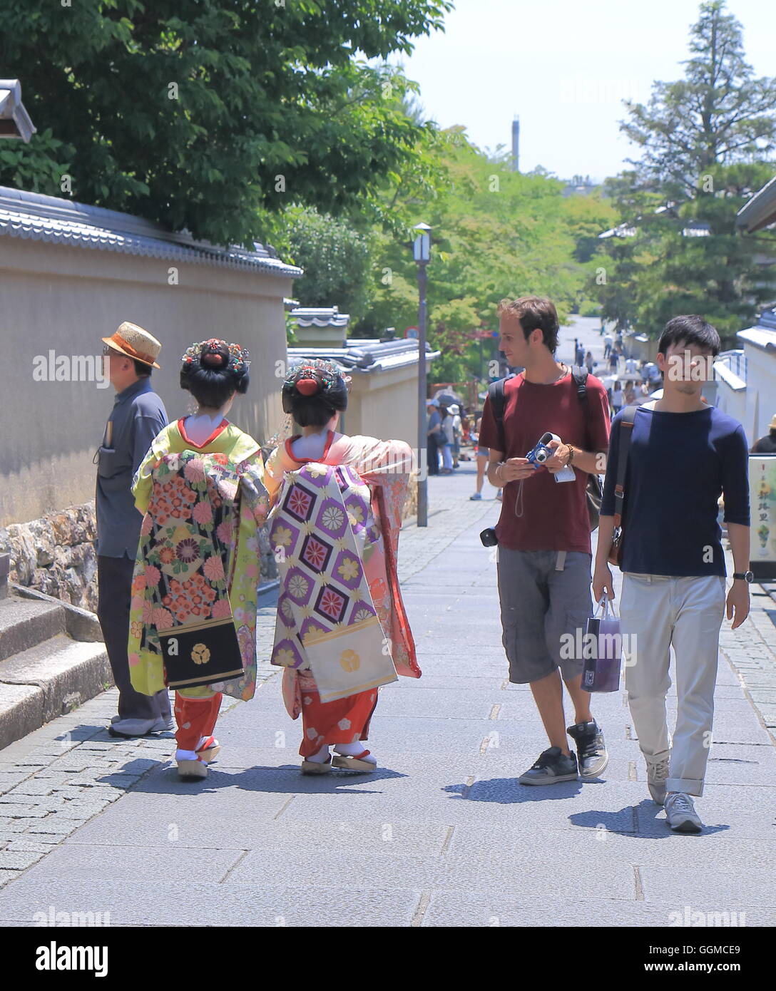 Geisha girls walk on street in Higashiyama in Kyoto Japan Stock Photo ...