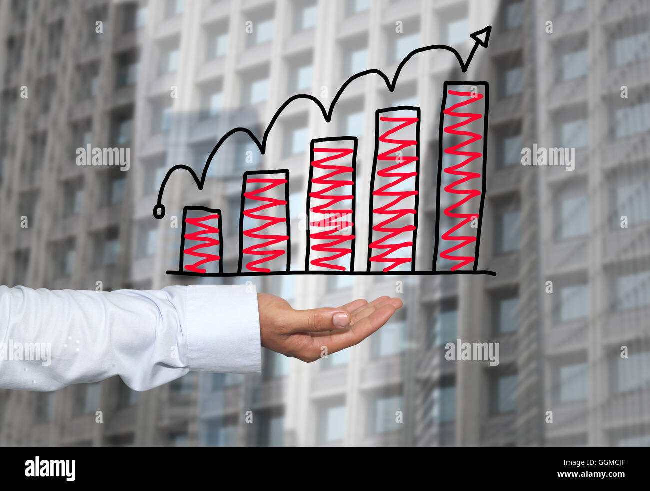 Drawing graphics growing graph on hand to concept of investment profit ...
