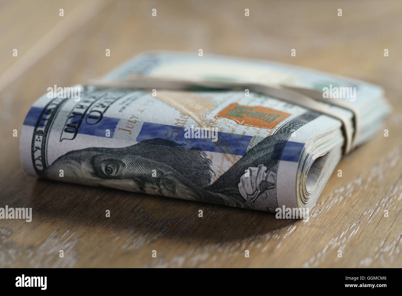bunch of dollars on oak wood table Stock Photo - Alamy