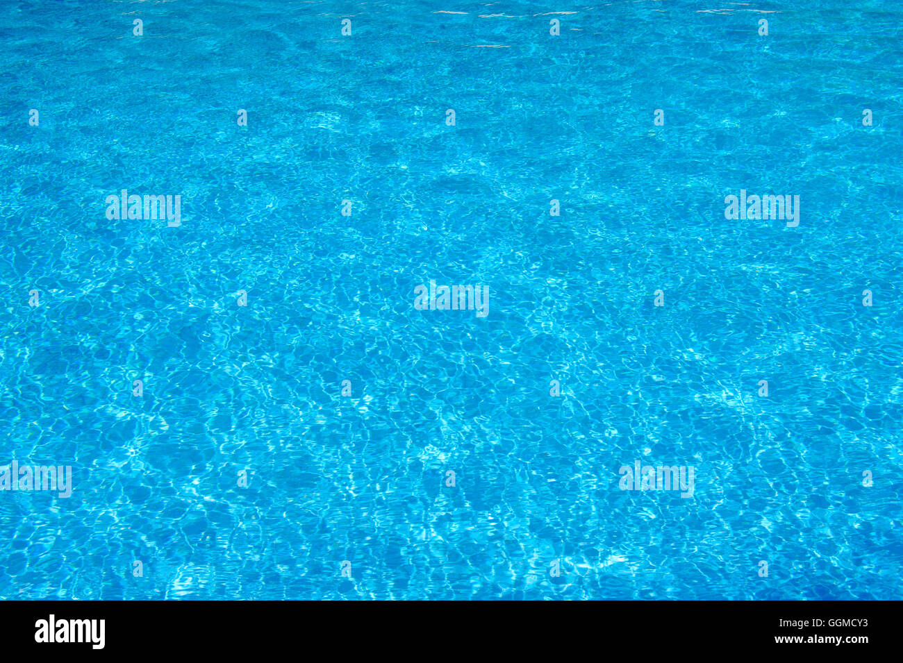 Swimming pool blue water surface texture with wave sun light effect ...