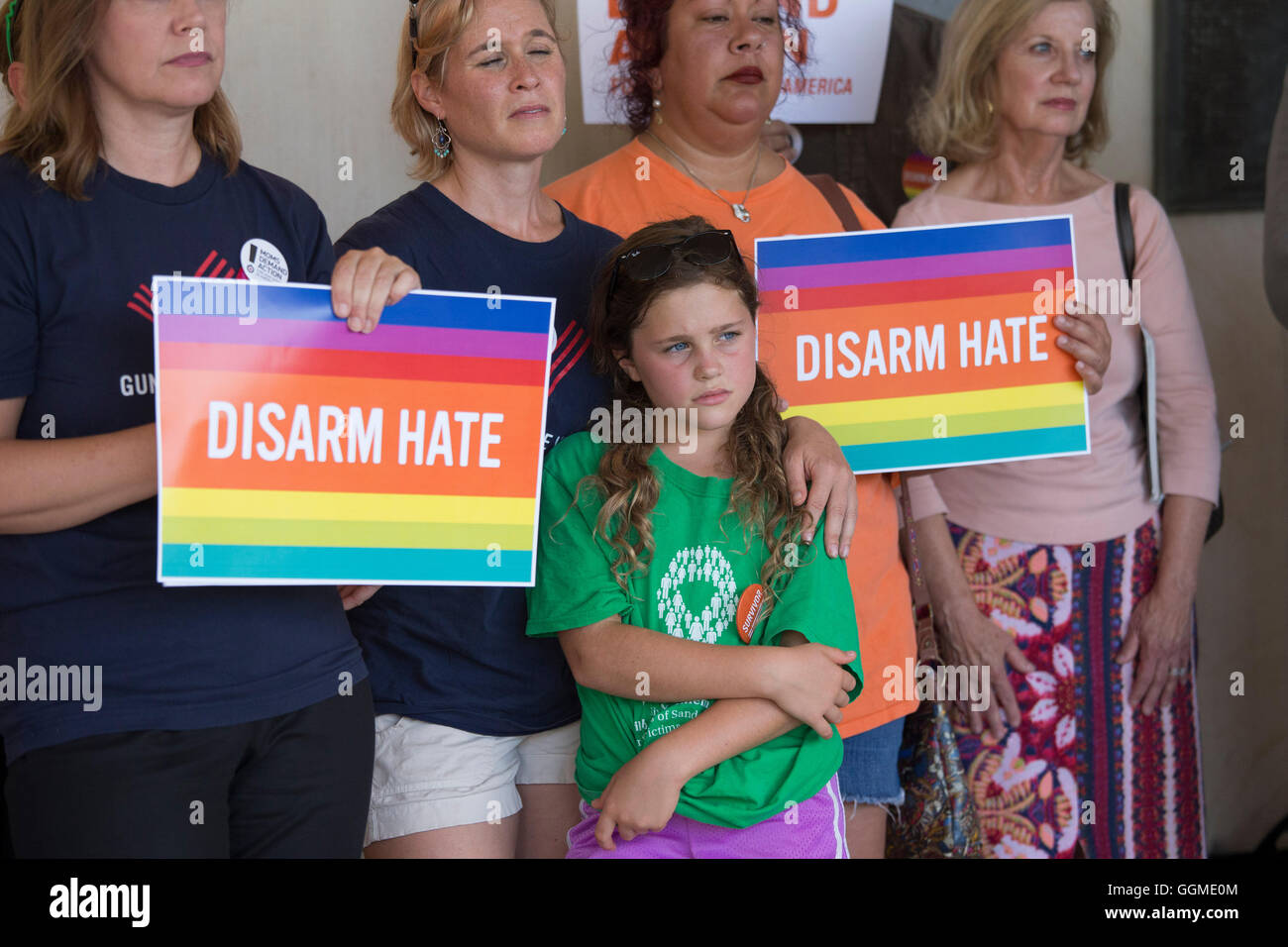 Activists hold anti-gun violence signs at rally outside AFL-CIO ...