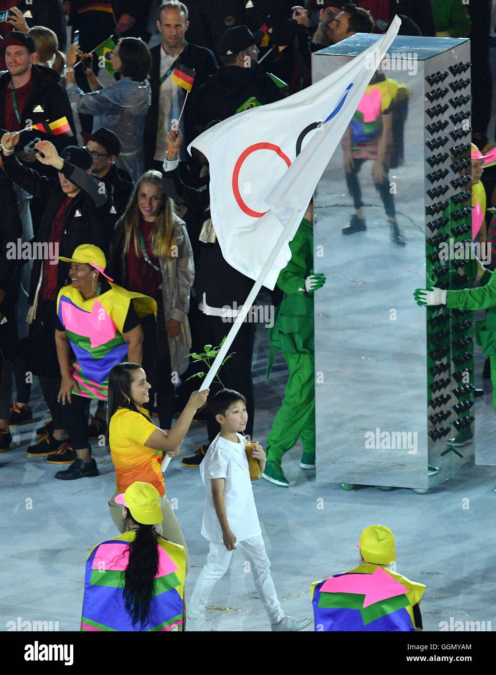Rio de Janeiro, Brazil. 5th Aug, 2016. A woman carries the Olympic flag ...