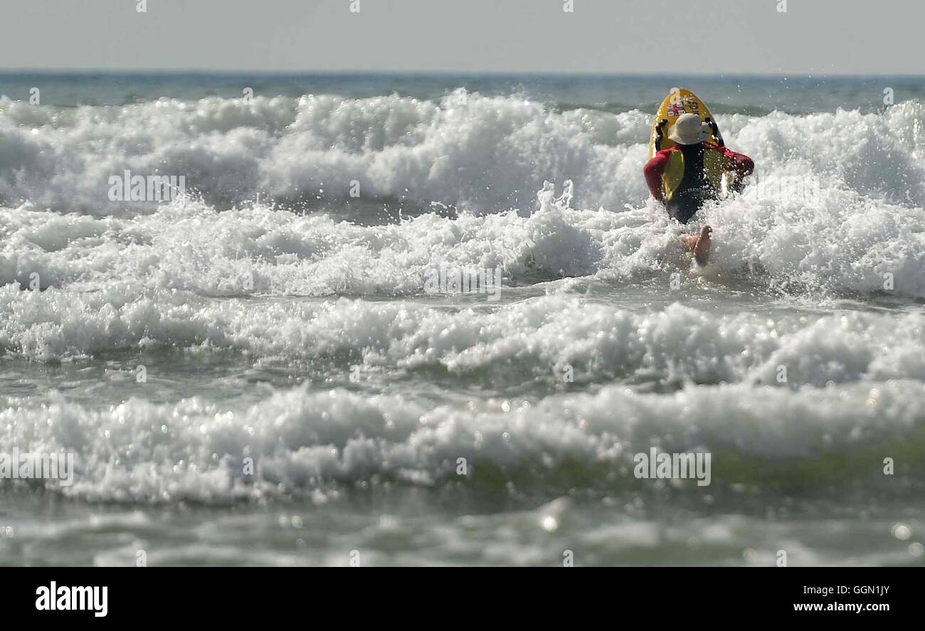 Beach lifeguard, RNLI lifeguards, Polzeath beach, Cornwall, UK Stock ...