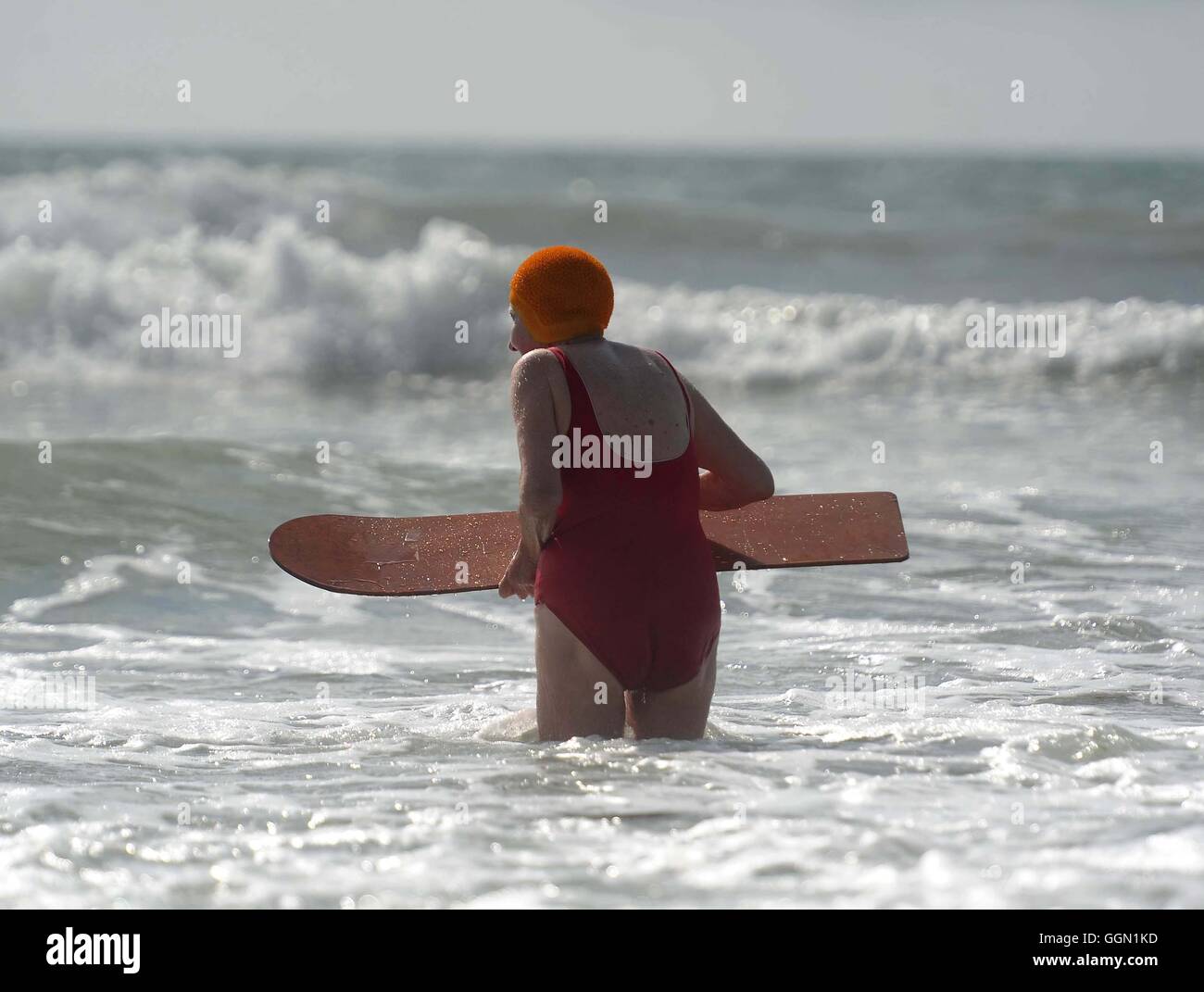 Elderly woman enjoys bodyboarding at Polzeath beach, Cornwall, UK Stock ...