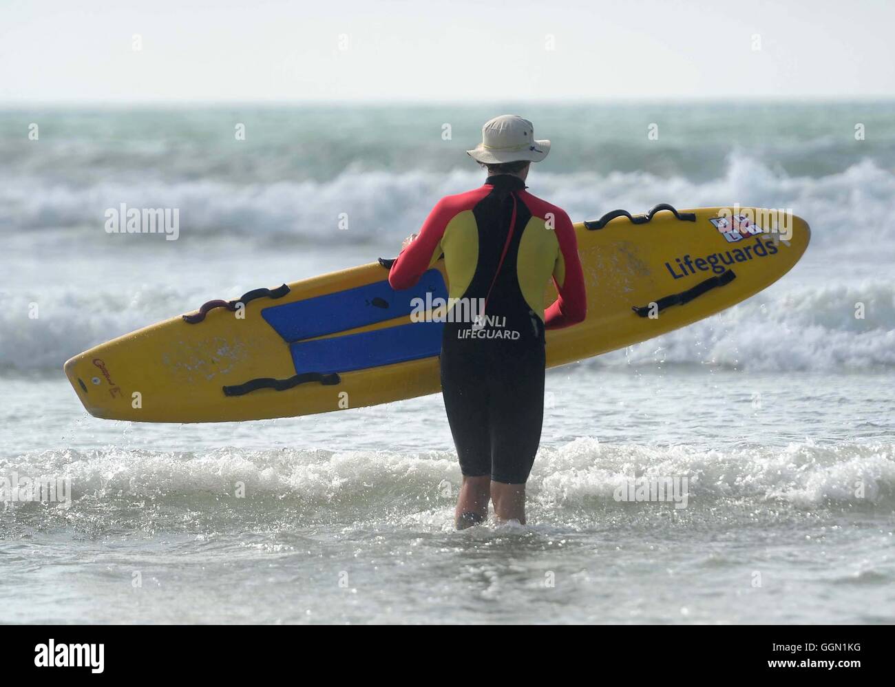 Beach lifeguard, RNLI lifeguards, Polzeath beach, Cornwall, UK Stock ...