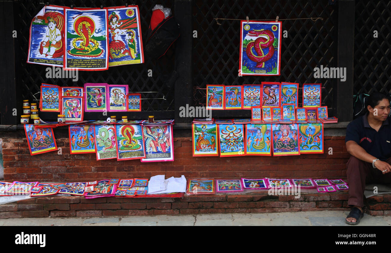 Kathmandu, Nepal. 6th Aug, 2016. A local vendor sells pictures of snake ...