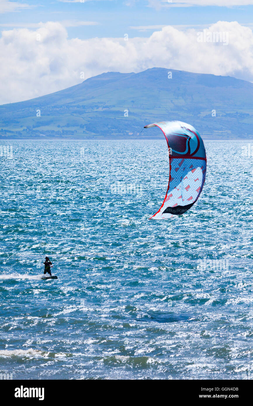 Kite surfer enjoyng the warm weather and sea at Newborough Beach ...