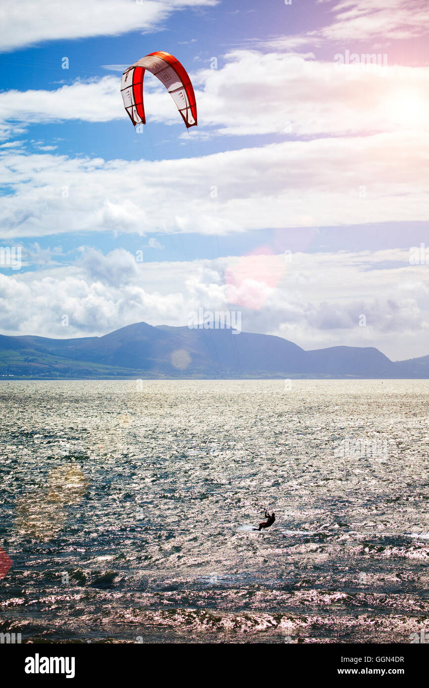 Kite surfer enjoyng the warm weather and sea at Newborough Beach ...