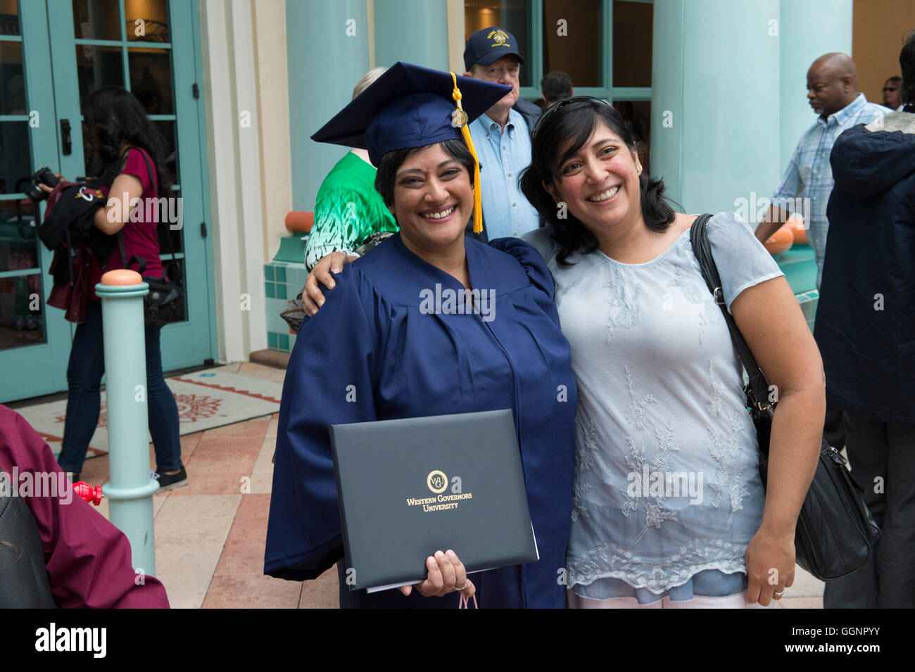 Graduate of Western Governors University poses with family member after ...