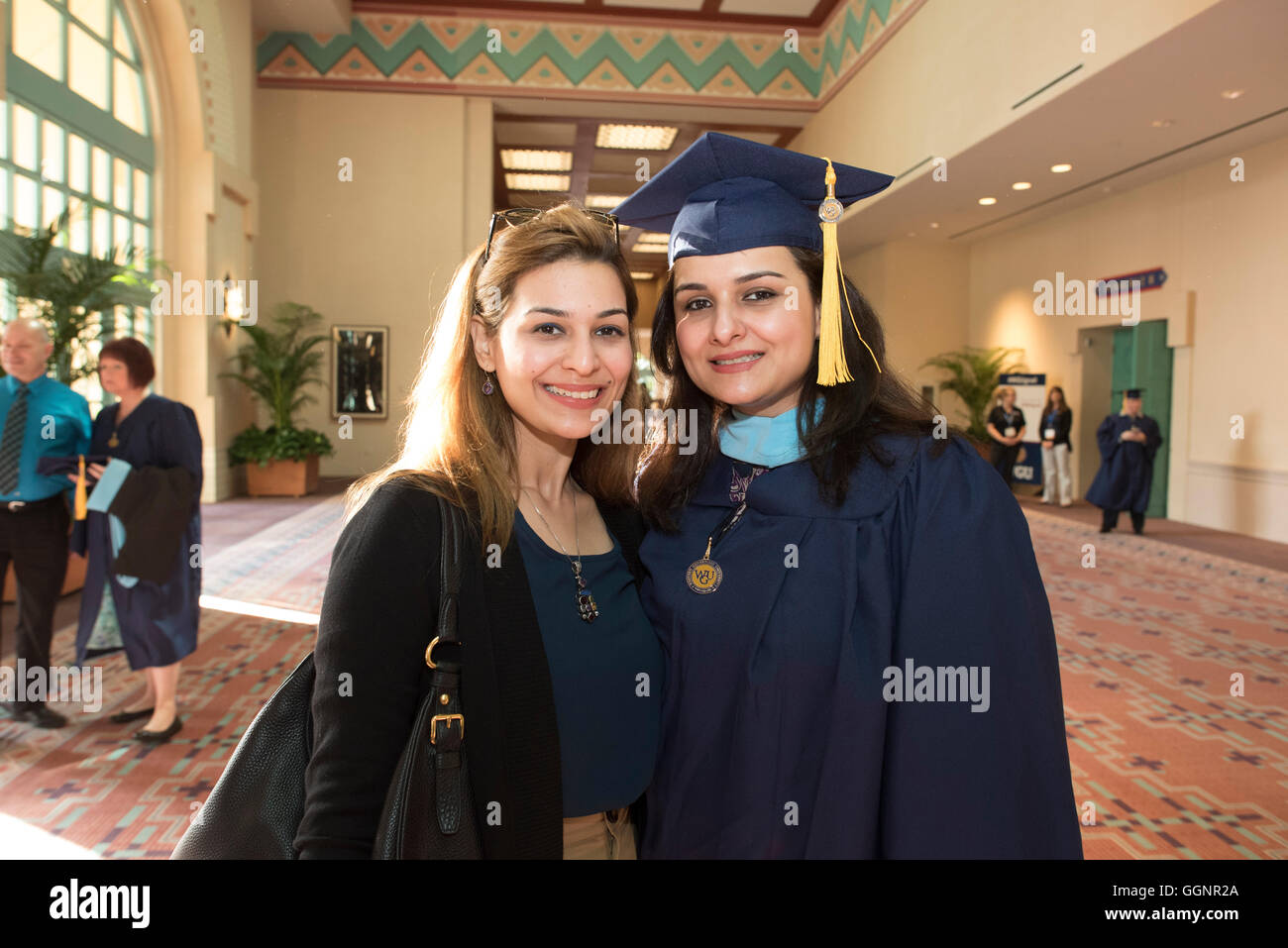 Graduate of Western Governors University poses with friend after ...