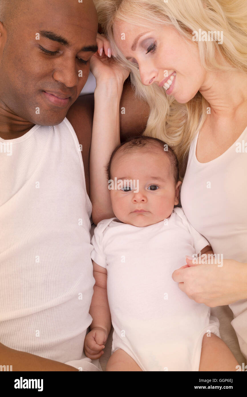Cheerful interracial family cuddling Stock Photo - Alamy