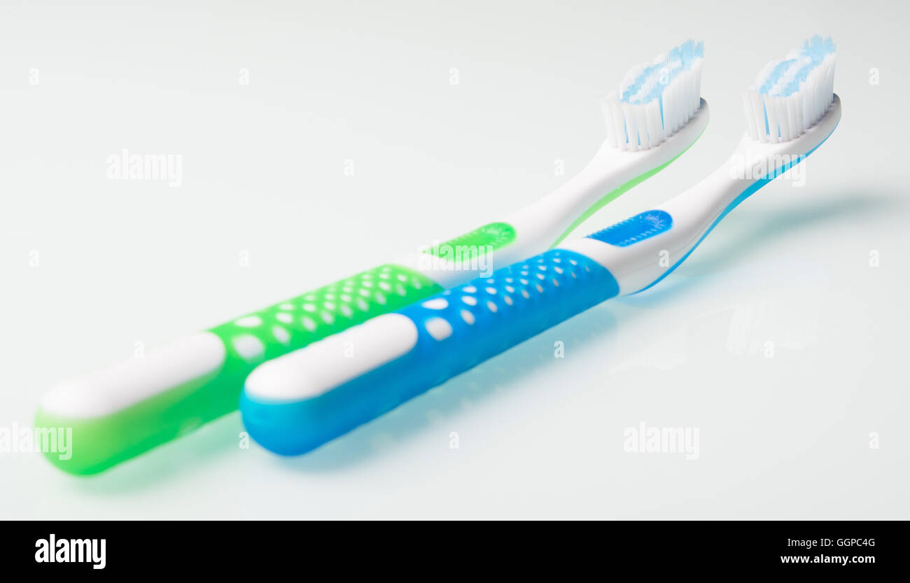 pair of toothbrushes on the glass table Stock Photo - Alamy