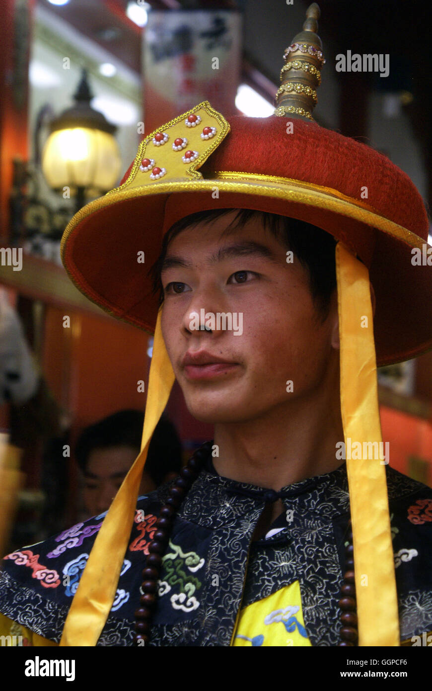 A young man dressed in period costume drums up business at a souvenir ...