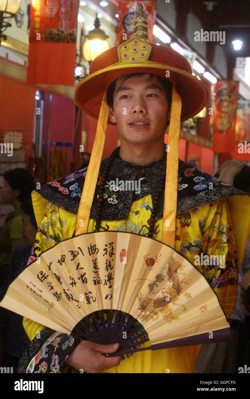 A young man dressed in period costume drums up business at a souvenir ...