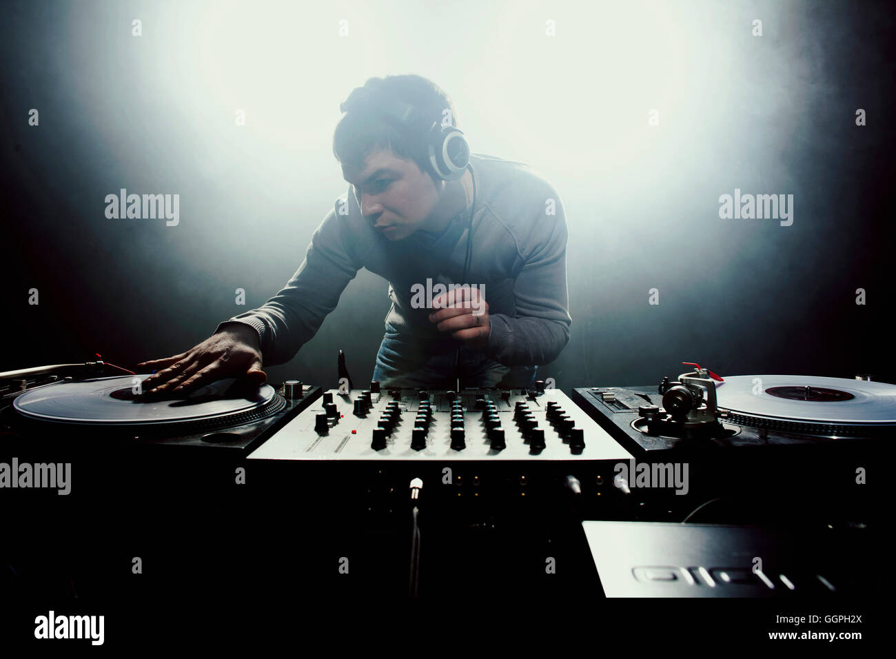 Caucasian disc jockey playing music in nightclub Stock Photo - Alamy