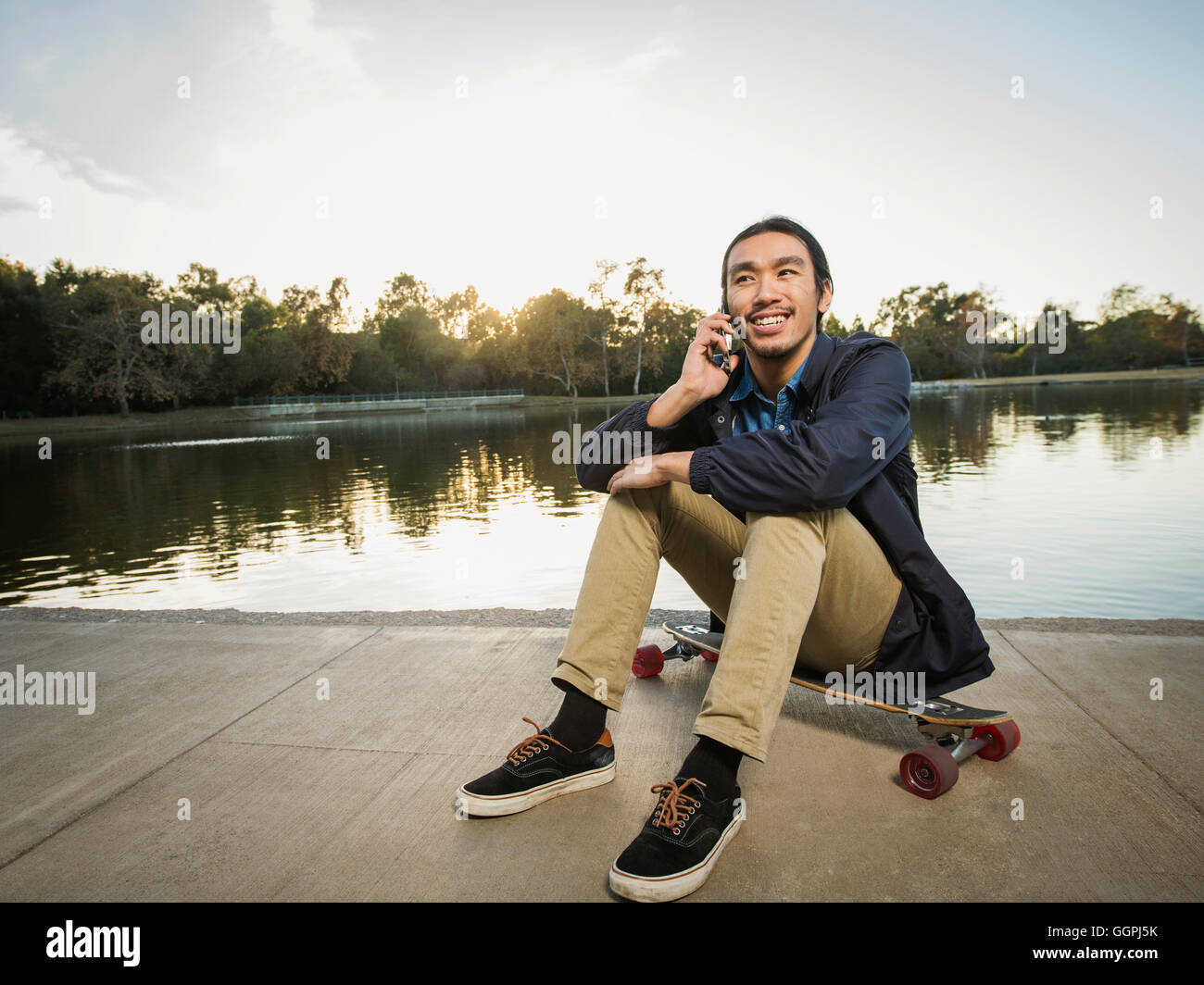 Smiling chinese man sitting on hi-res stock photography and images - Alamy