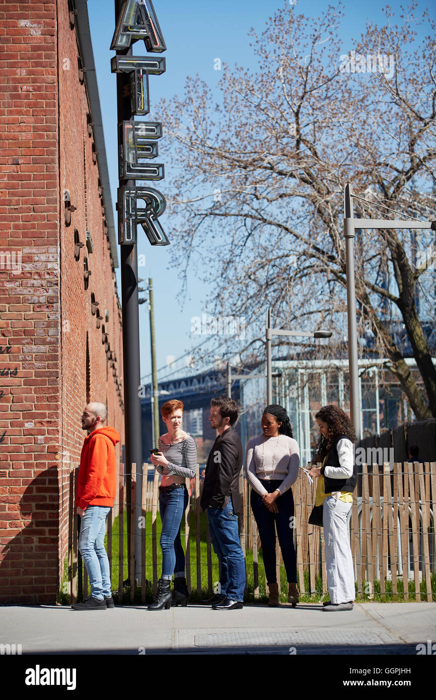 Friends waiting in line at theater Stock Photo - Alamy