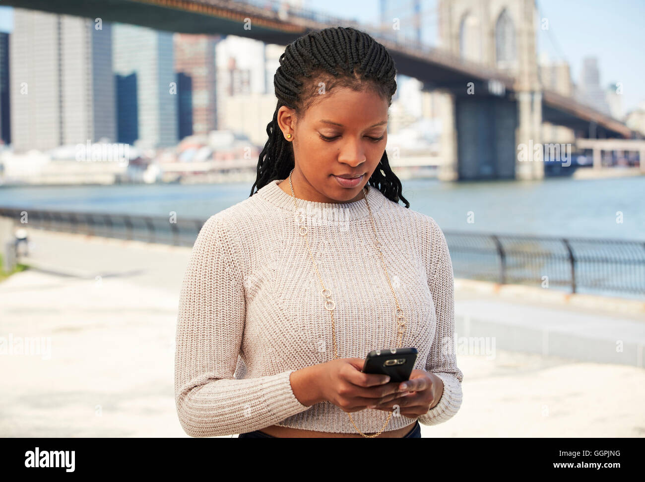Black woman using cell phone at waterfront Stock Photo - Alamy