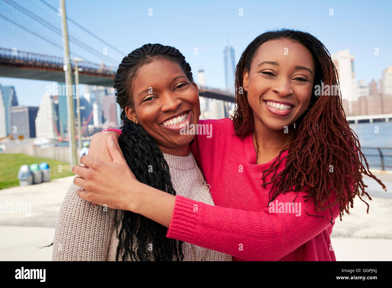 Black women hugging at waterfront Stock Photo - Alamy