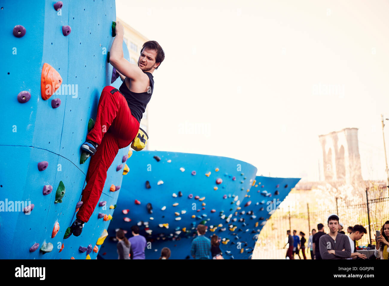 Caucasian man climbing outdoor climbing wall Stock Photo - Alamy