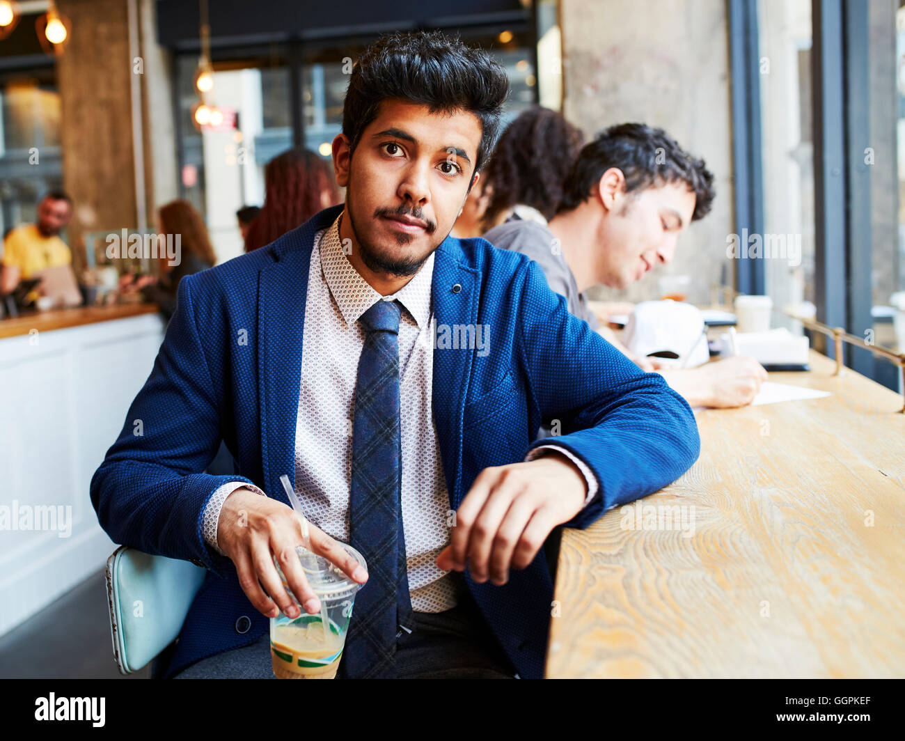 Man drinking cold beverage in cafe Stock Photo - Alamy