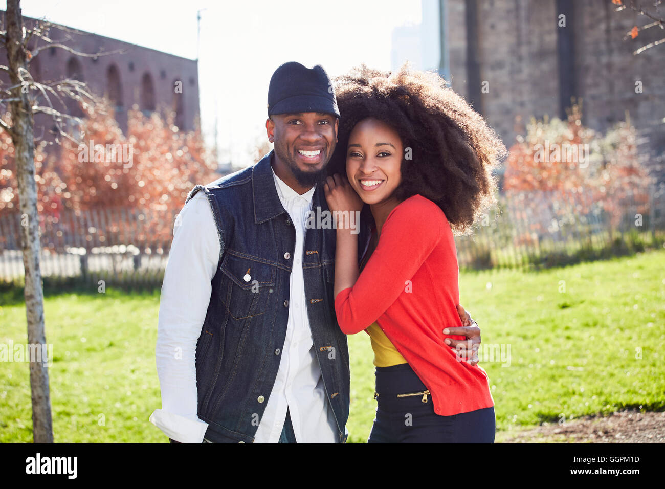 Smiling couple hugging in city Stock Photo - Alamy