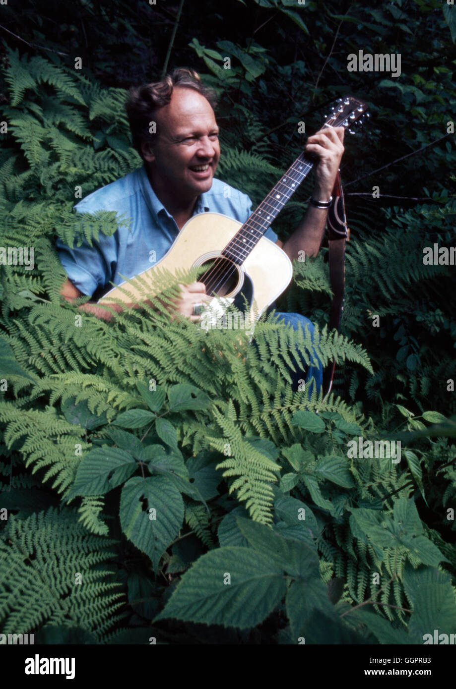 Author James Dickey, best known for his novel Deliverance, playing ...