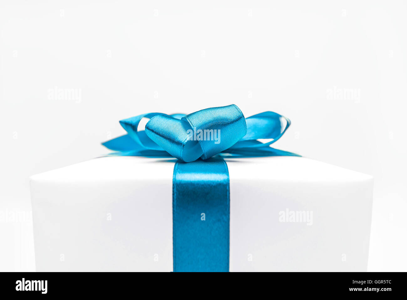 White gift box with red ribbon bow Stock Photo - Alamy