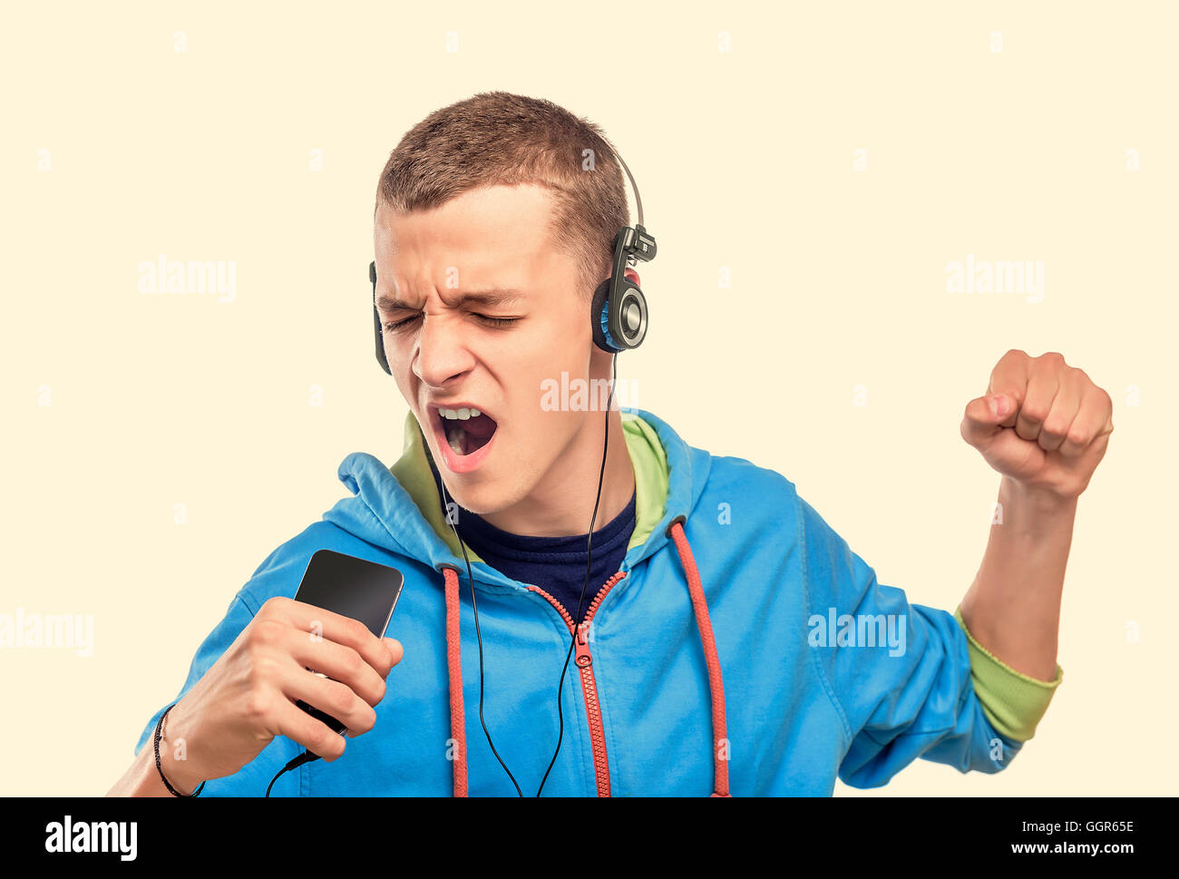 Attractive young man sing and listening music with headphones. Toned ...