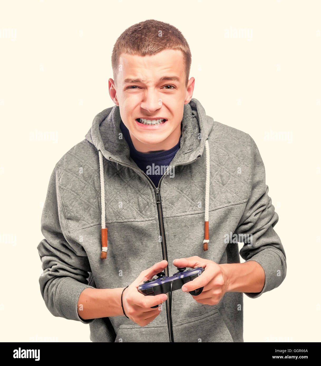 Young man with a joystick for game console. Toned photo Stock Photo - Alamy