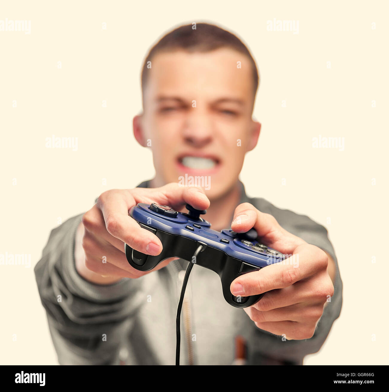 Young man with a joystick for game console. Toned photo Stock Photo - Alamy