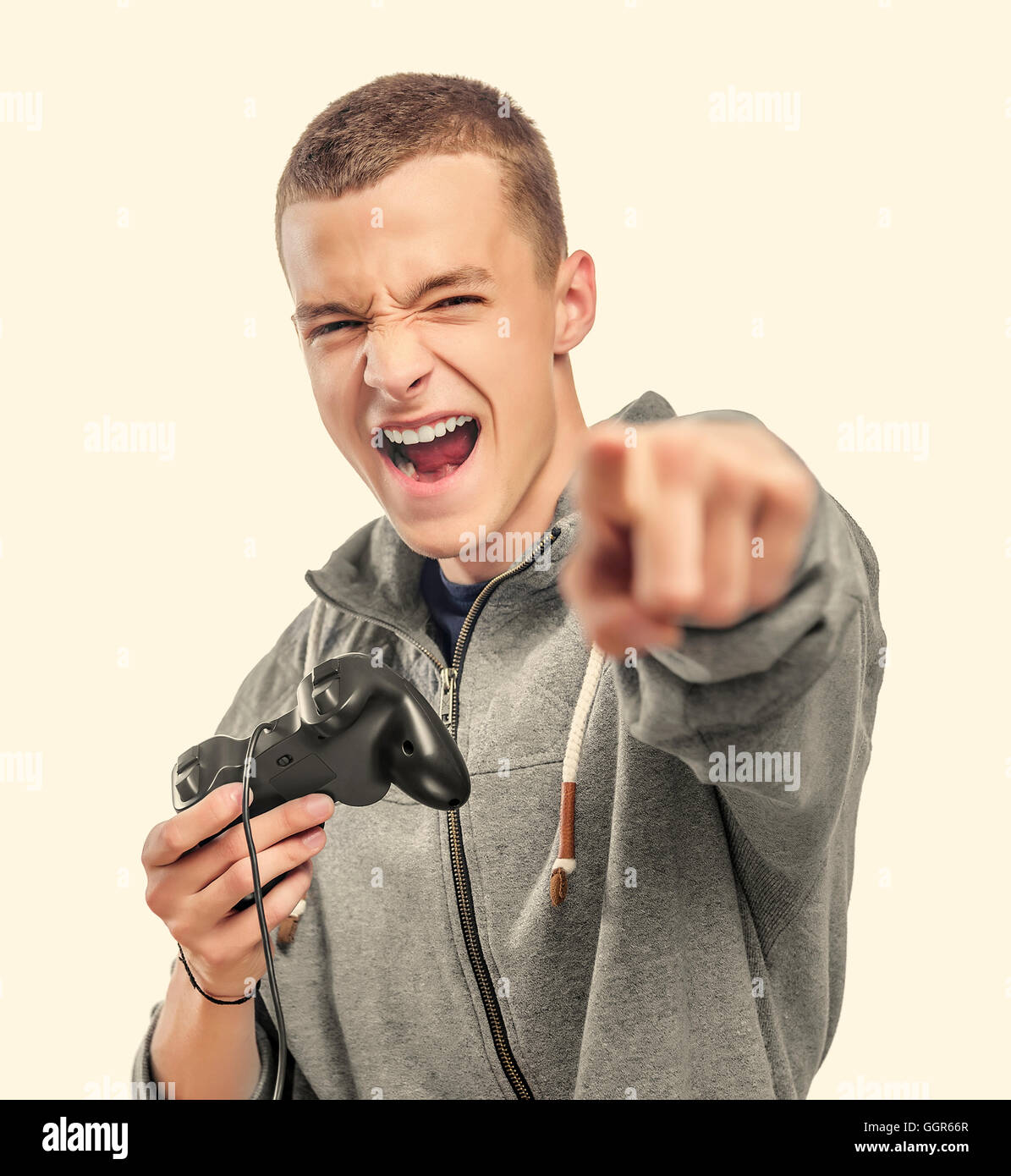 Young man with a joystick for game console showing on you. Toned photo ...